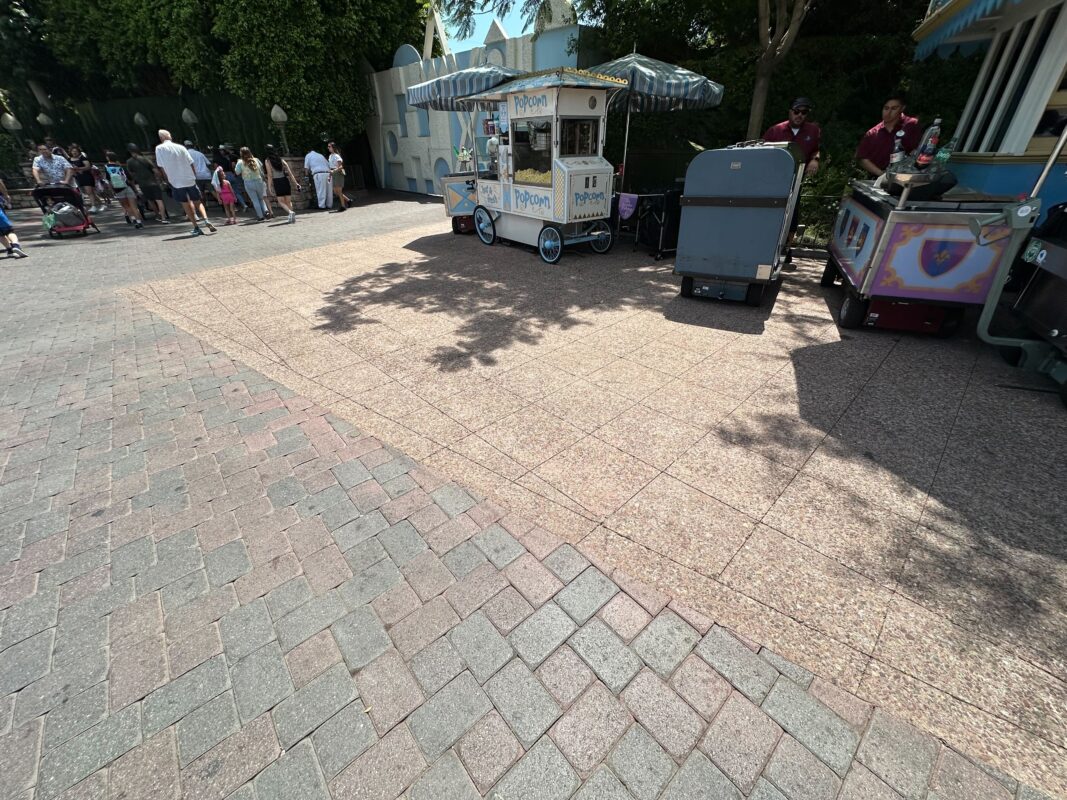 New Pavement Revealed Near "it's a small world," Construction Walls Up ...